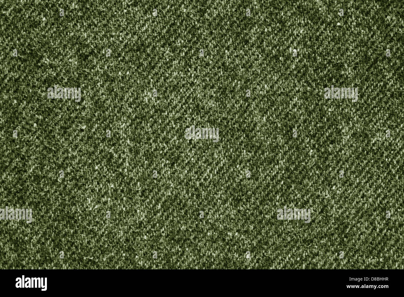 A close-up of olive green denim fabric showing its textured weave. The ...