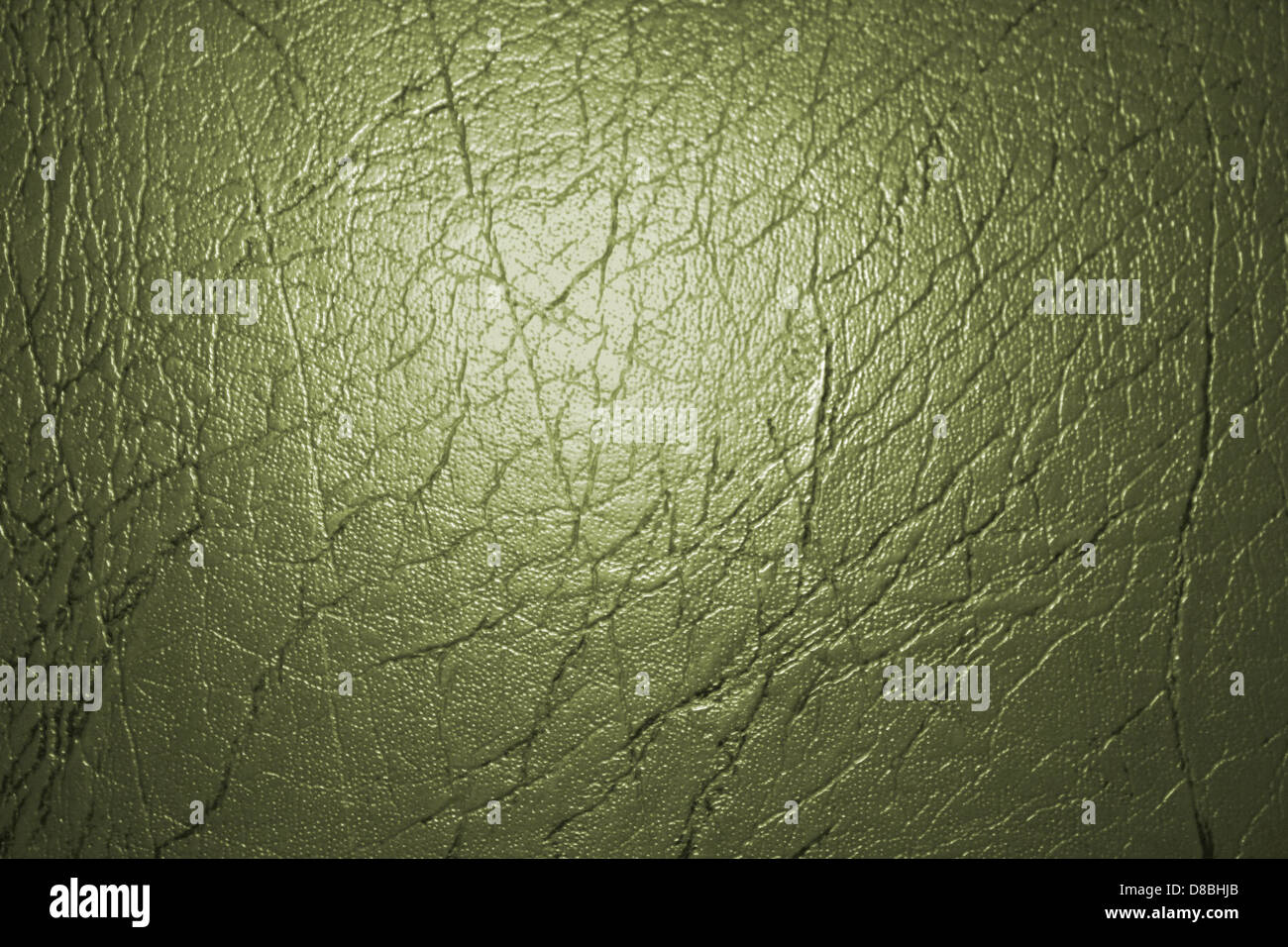 A close-up of olive green leather, showing its soft texture and ...