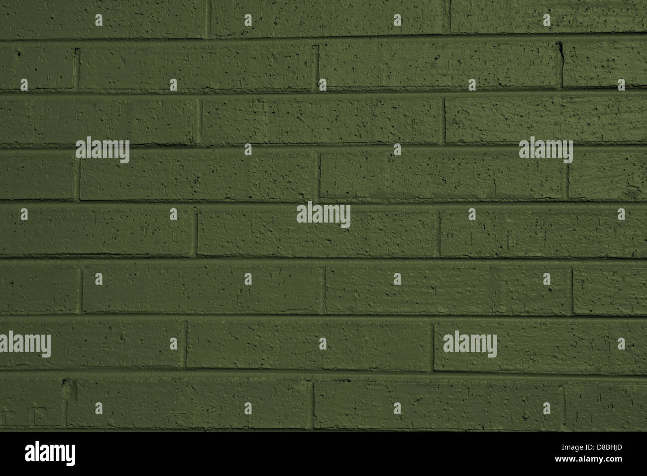 A close-up of an olive green painted brick wall texture. The smooth ...