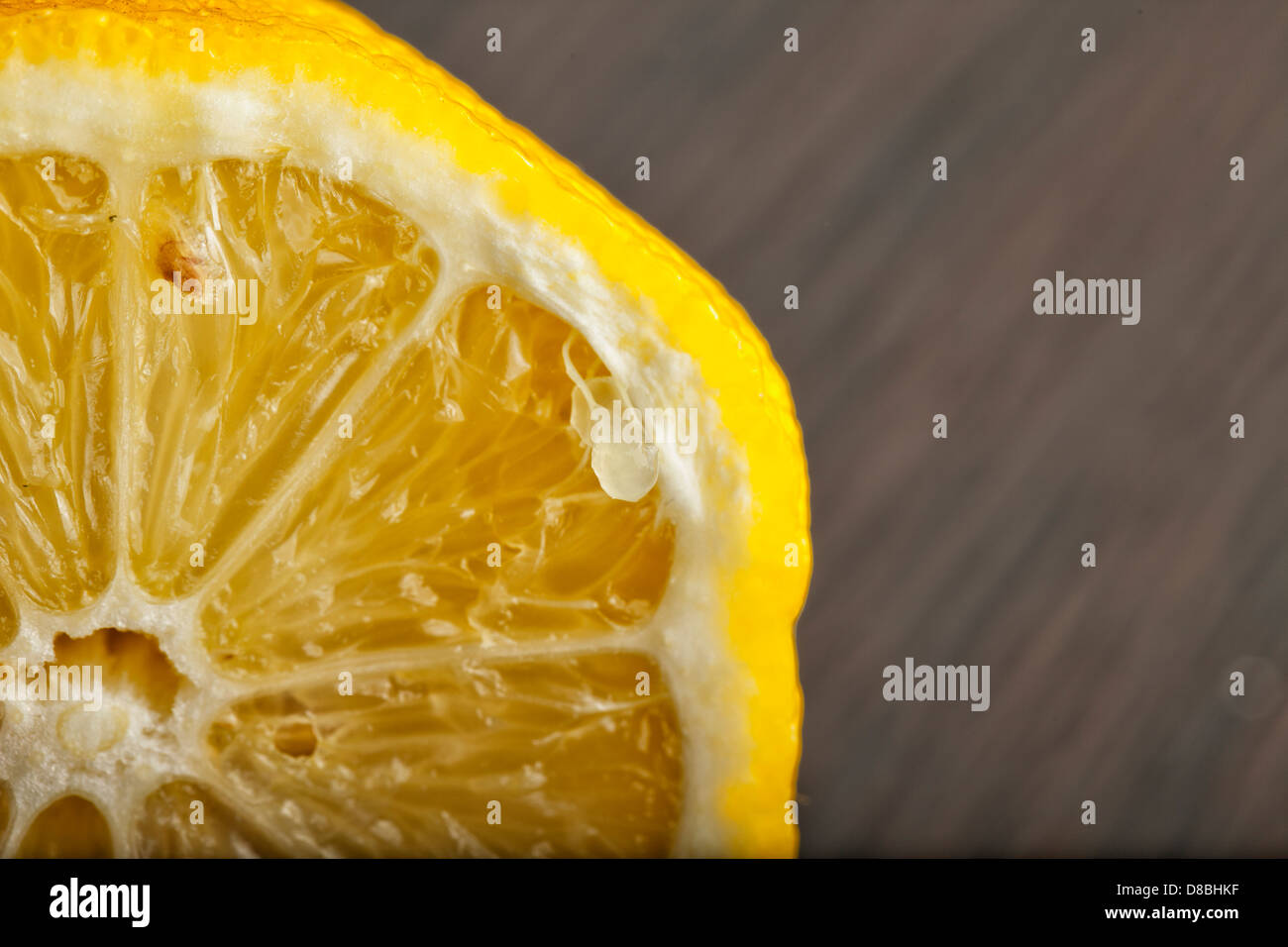 Close up of part of a lemon, wooden background Stock Photo - Alamy