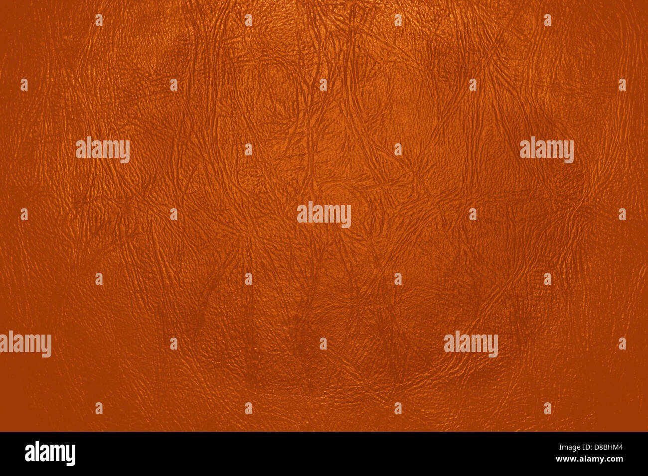 A close-up image of orange leather, highlighting the smooth, supple ...