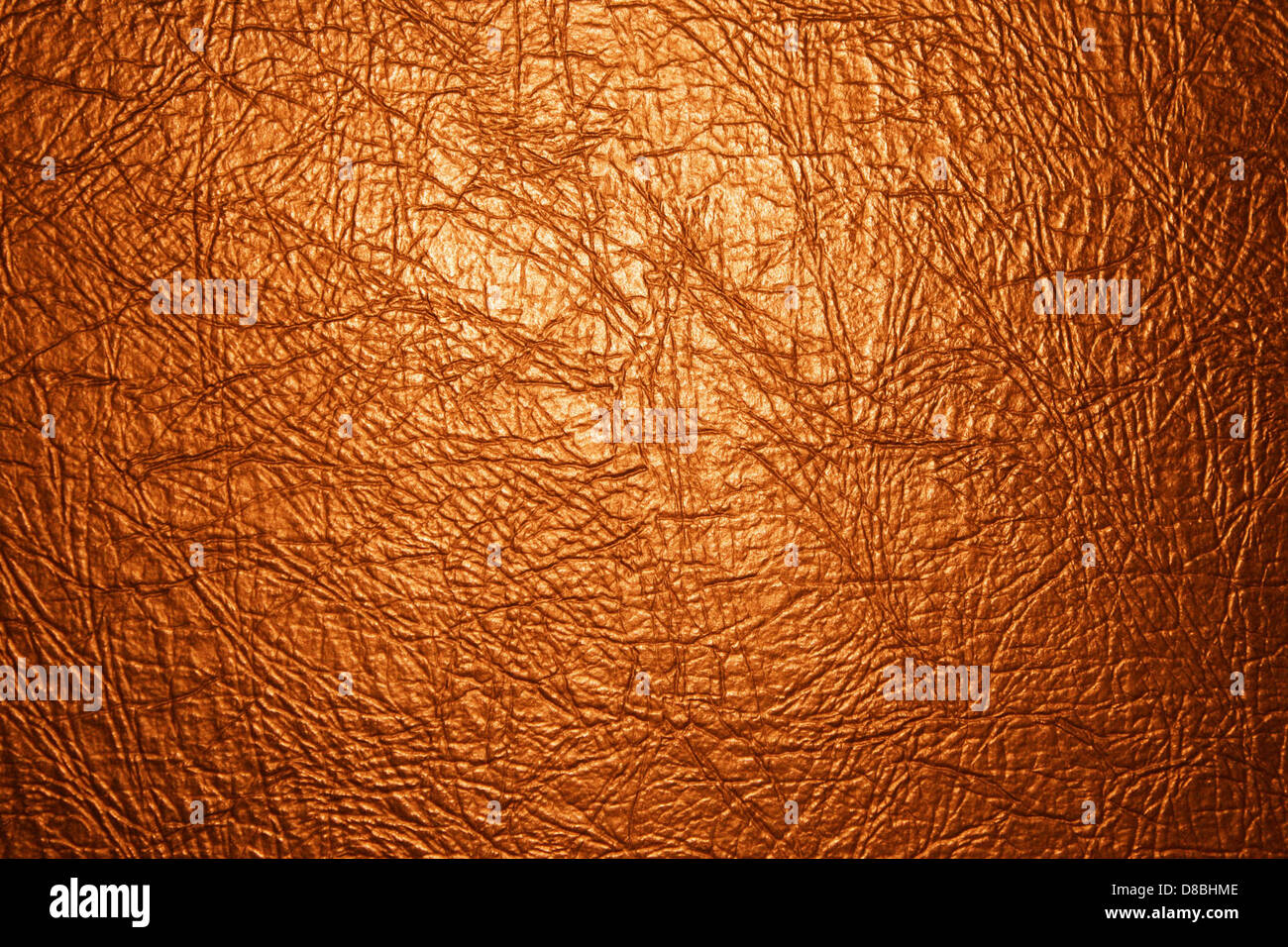 This image shows a close-up of orange leather texture. The leather has ...