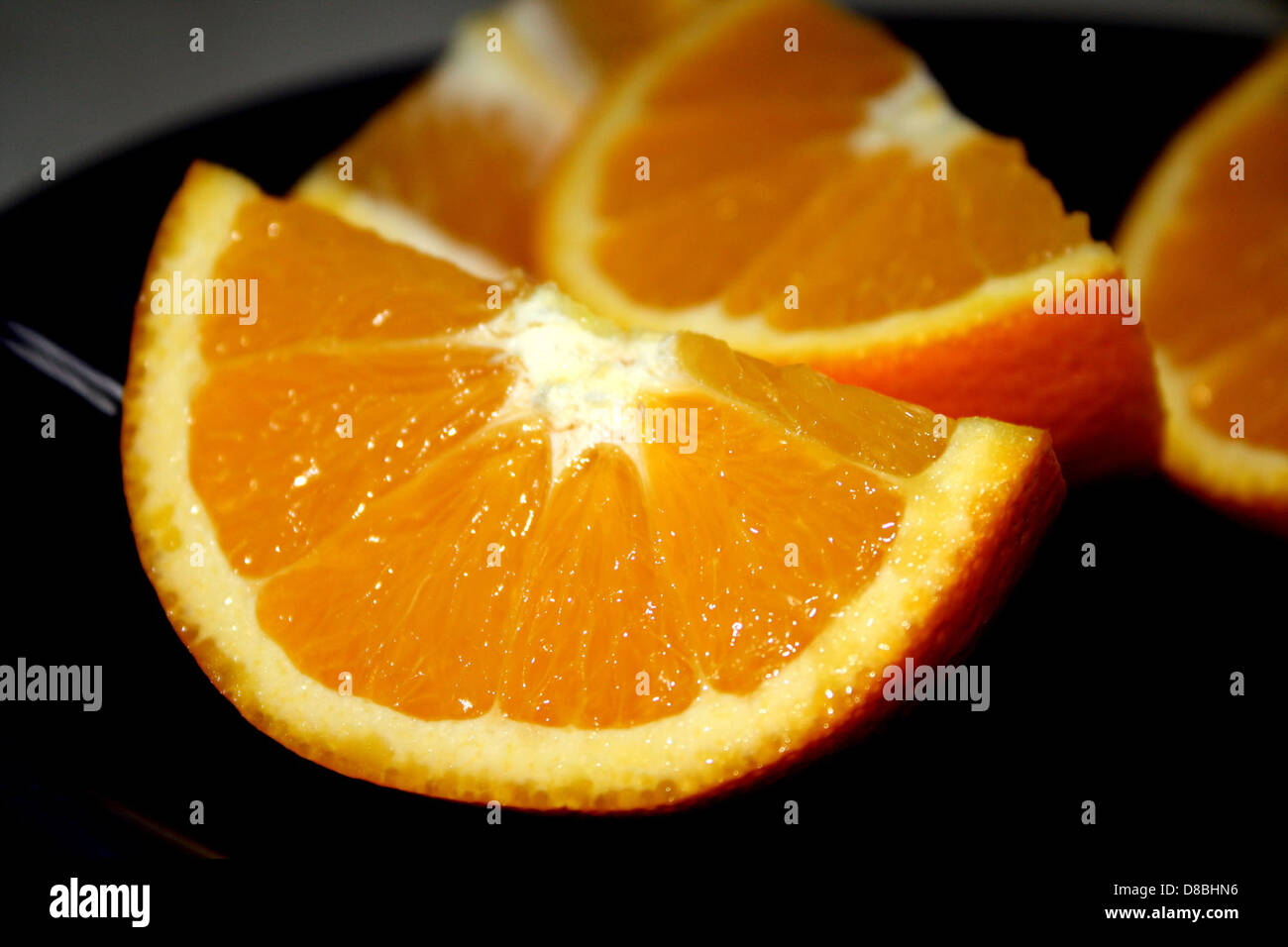 A close-up of orange quarters, showing the juicy fruit segments in ...