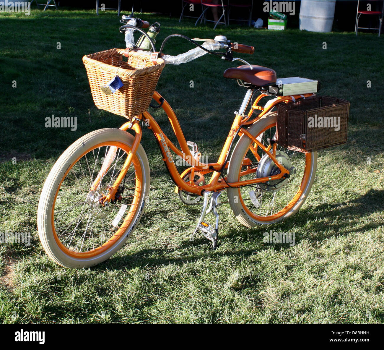 This image shows a bright orange bicycle, featuring a sleek design and ...