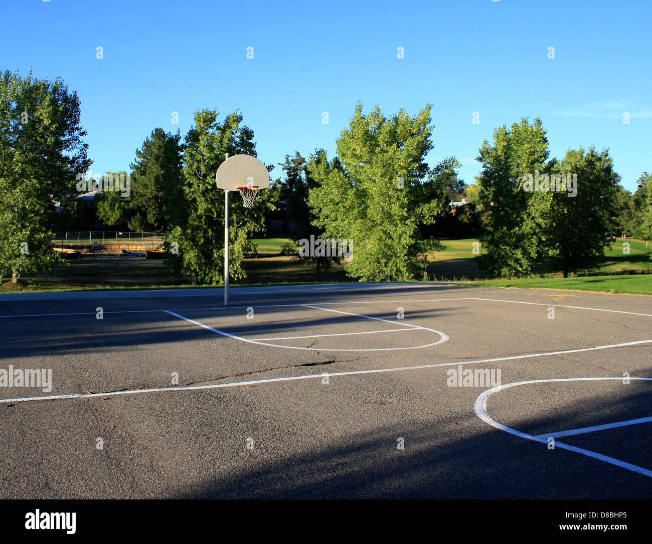 An outdoor basketball court set up with basketball hoops, marked lines ...