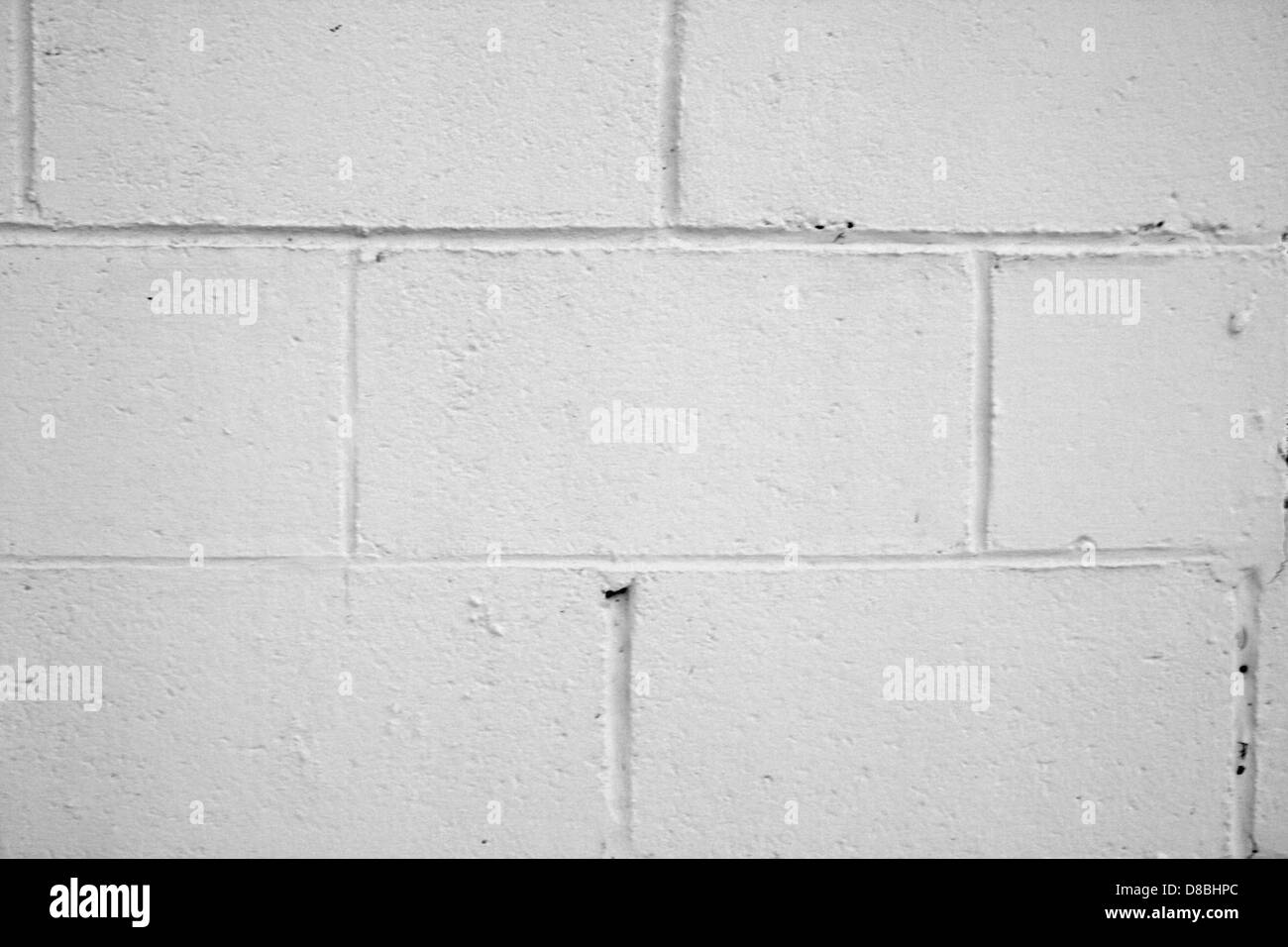 A painted cinder block wall with textured surface, featuring a colorful ...