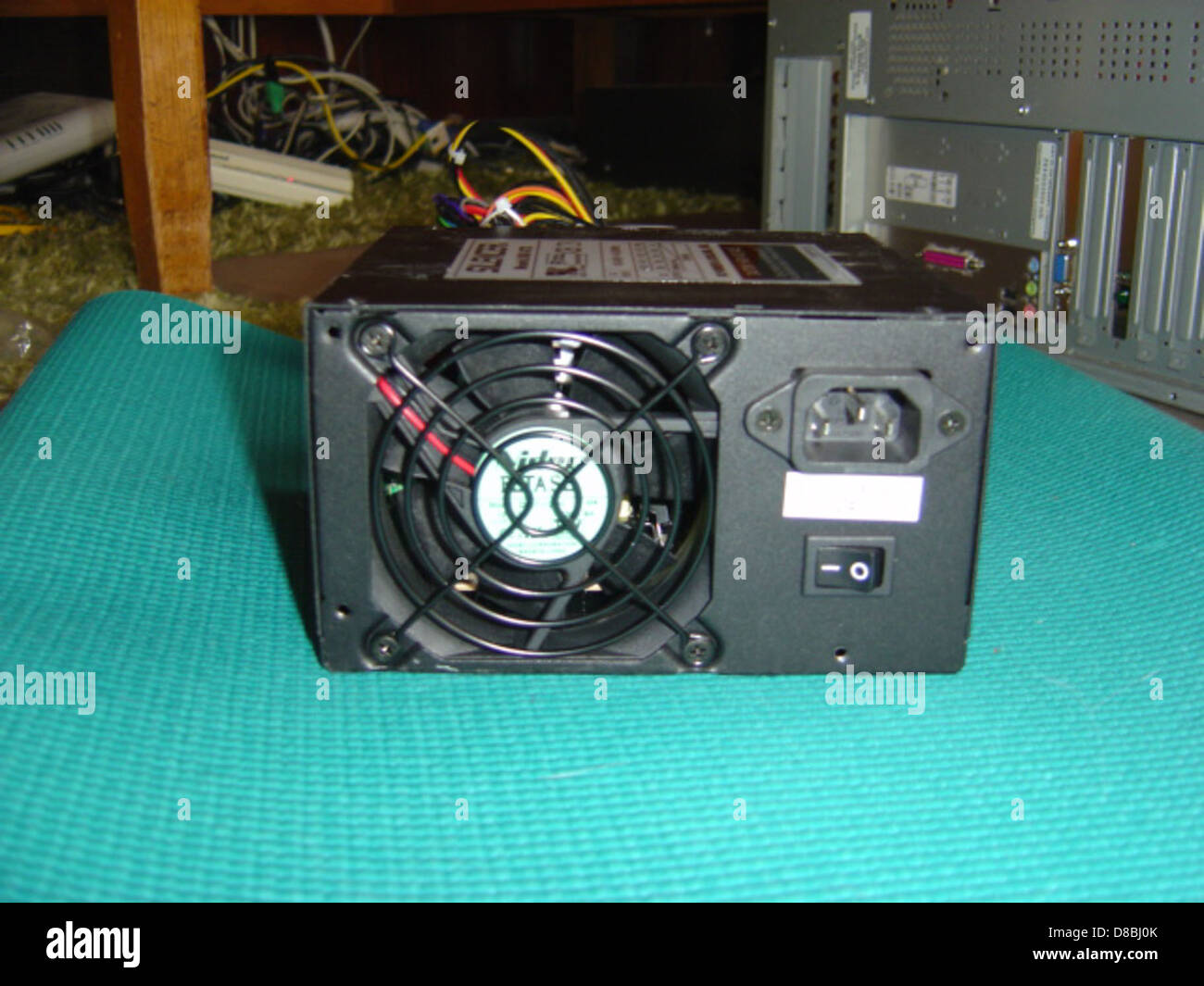 A photo showing a computer power supply unit, with visible components ...