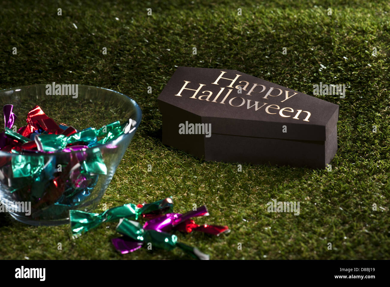 Halloween coffin on lawn with sweets and candies Stock Photo - Alamy