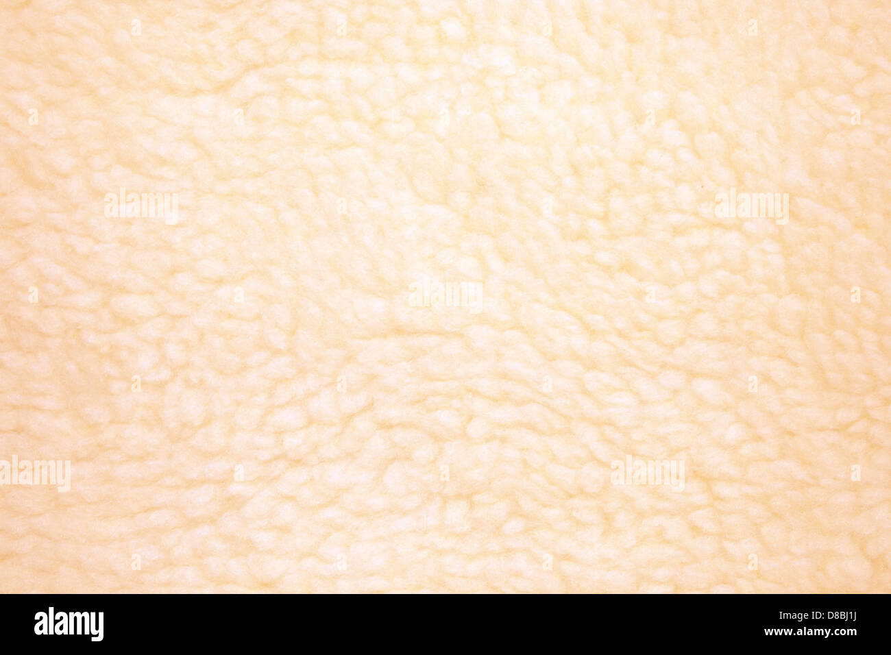 This image shows peach-colored fleece faux sherpa wool fabric. The ...