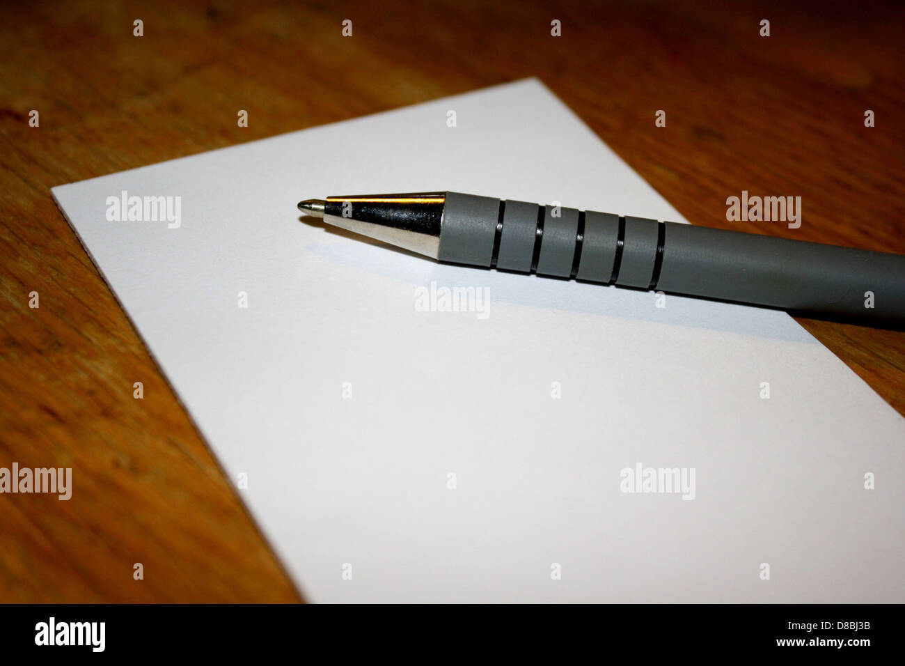 A close-up image of a pen and paper, emphasizing a simple writing setup ...