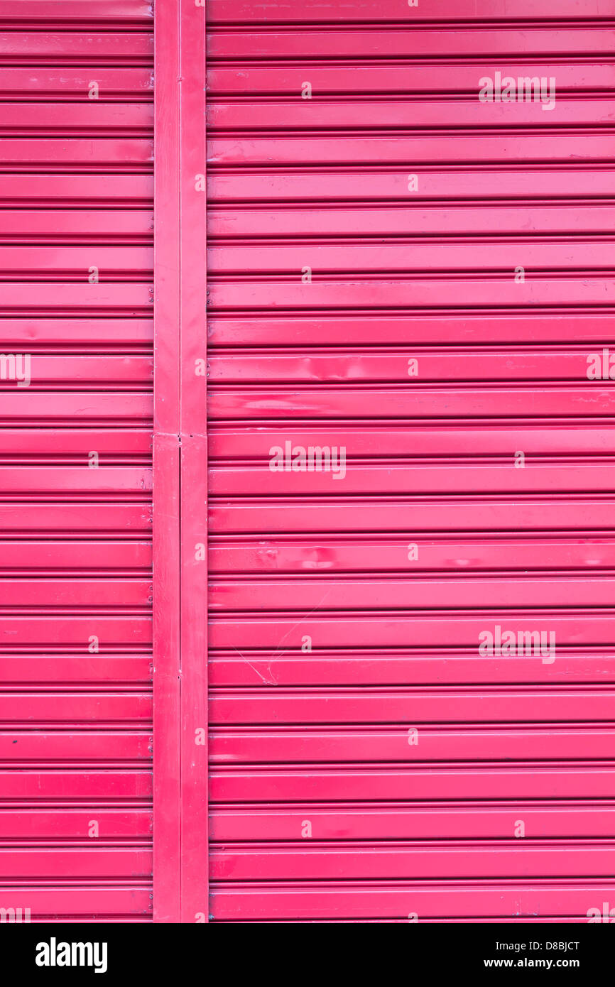 Red roller metal entry door of apartment Stock Photo - Alamy