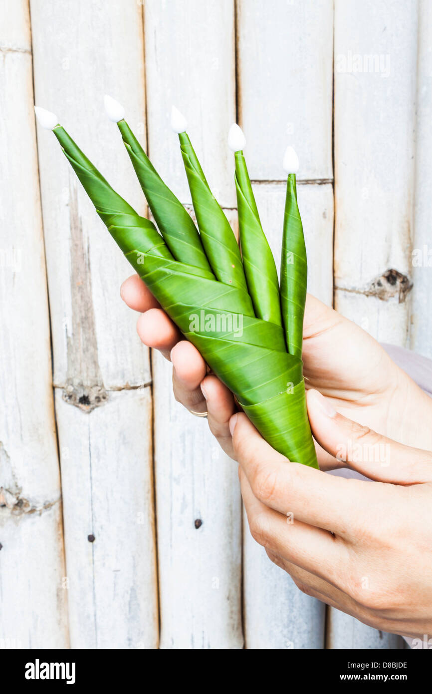 Hand hold a part of rice offering Stock Photo - Alamy