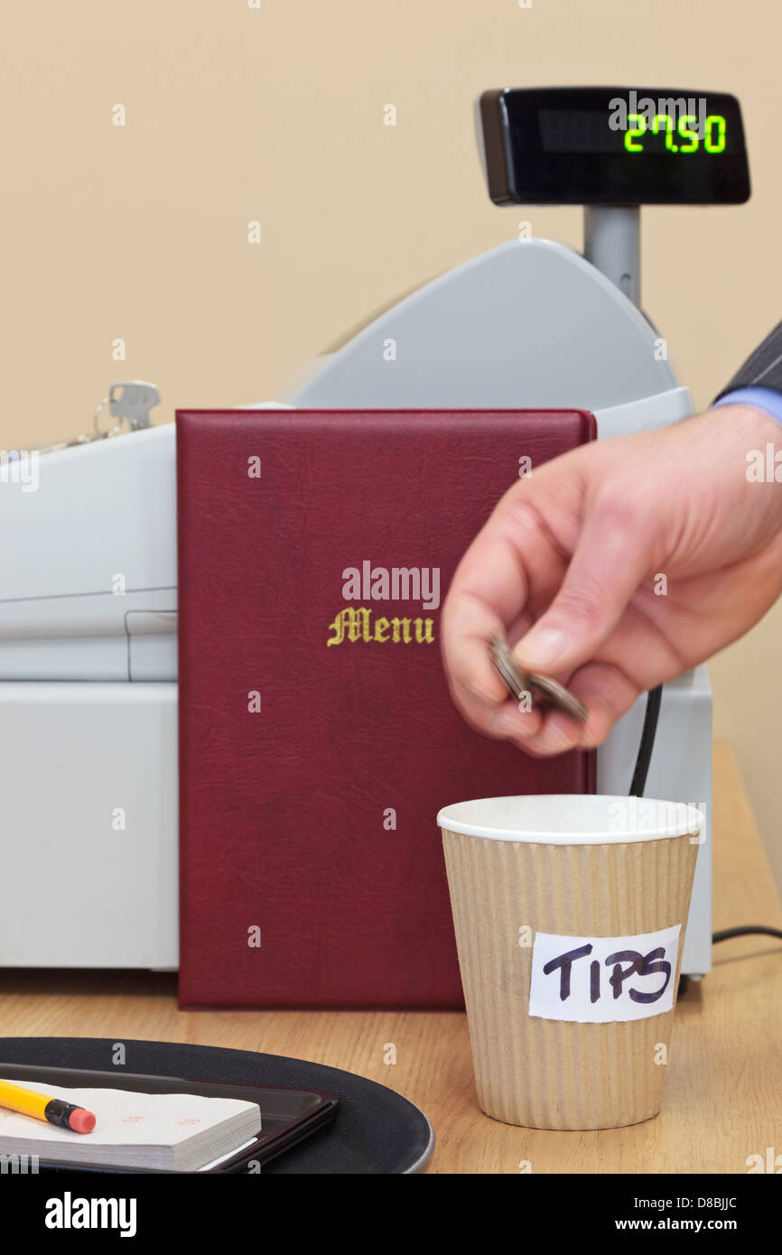 Hand dropping coins hi-res stock photography and images - Alamy