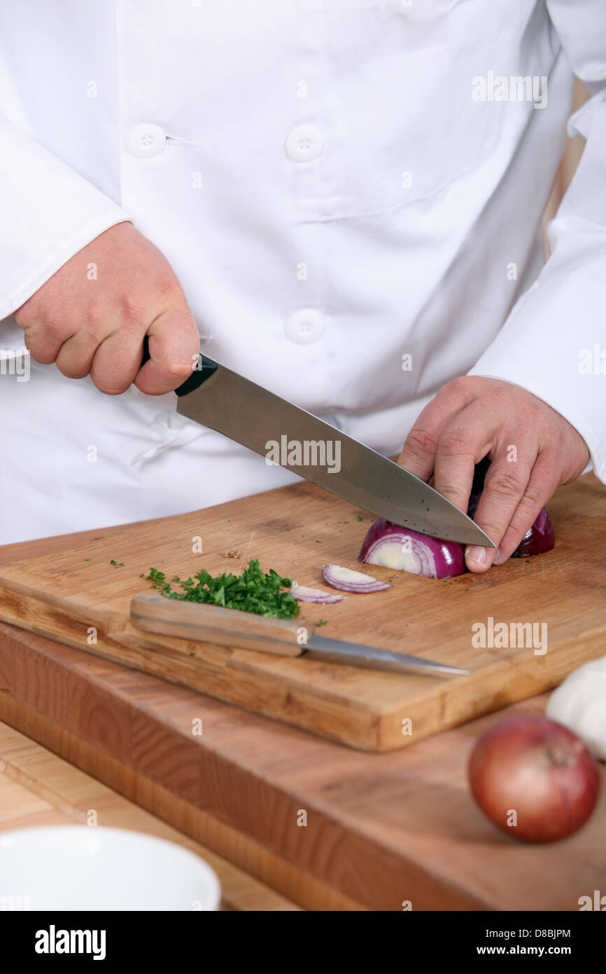 Chef chopping an onion Stock Photo - Alamy