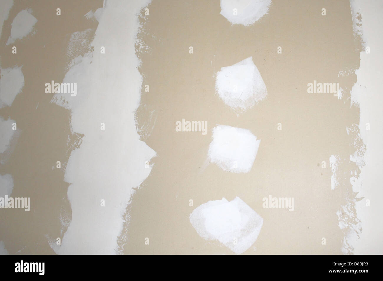 This image shows a close-up view of plaster drywall, a common building ...
