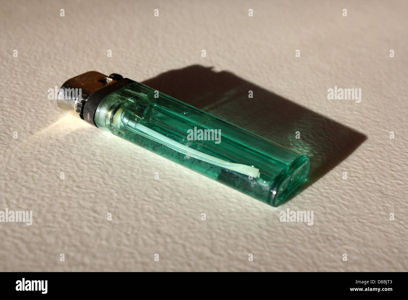 A close-up of a plastic lighter, typically used for lighting candles ...
