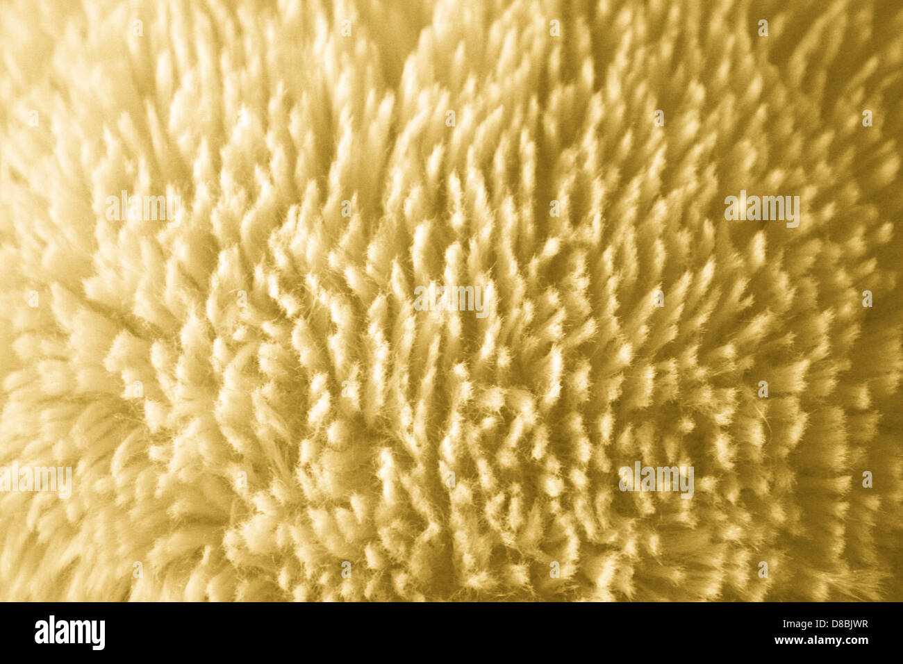 A close-up of plush ivory-colored fabric, showcasing its soft texture ...