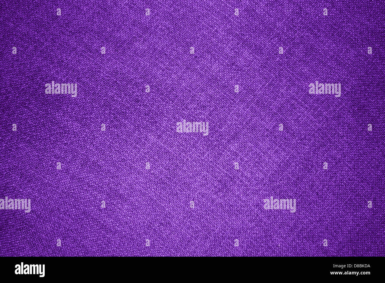 A close-up shot of textured purple fabric, showcasing its soft, rich ...