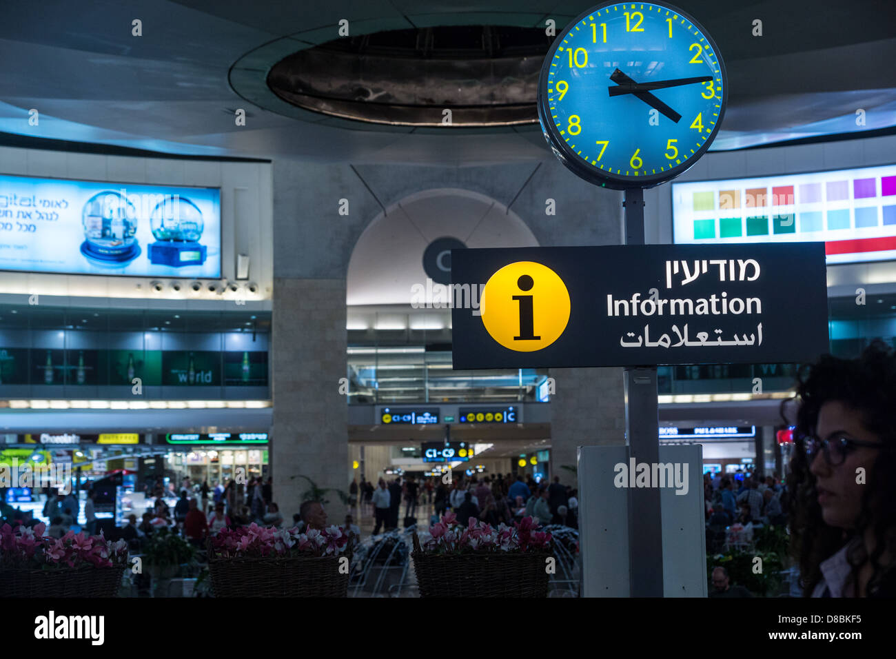 israel. An 'Information' sign and a clock at the Duty Free shops and ...