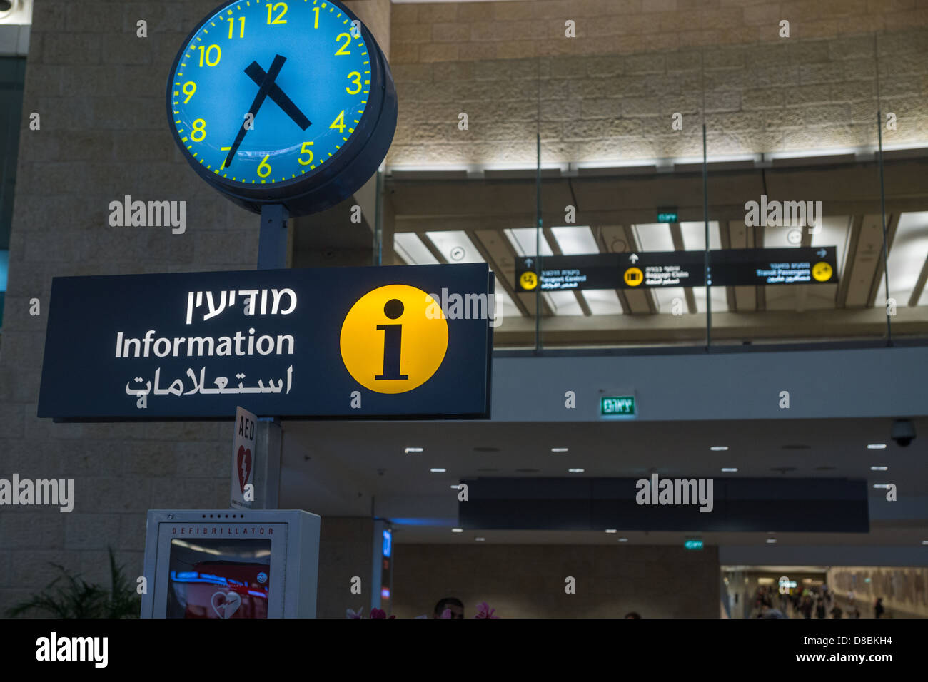 israel. An 'Information' sign and a clock at the Duty Free shops and ...