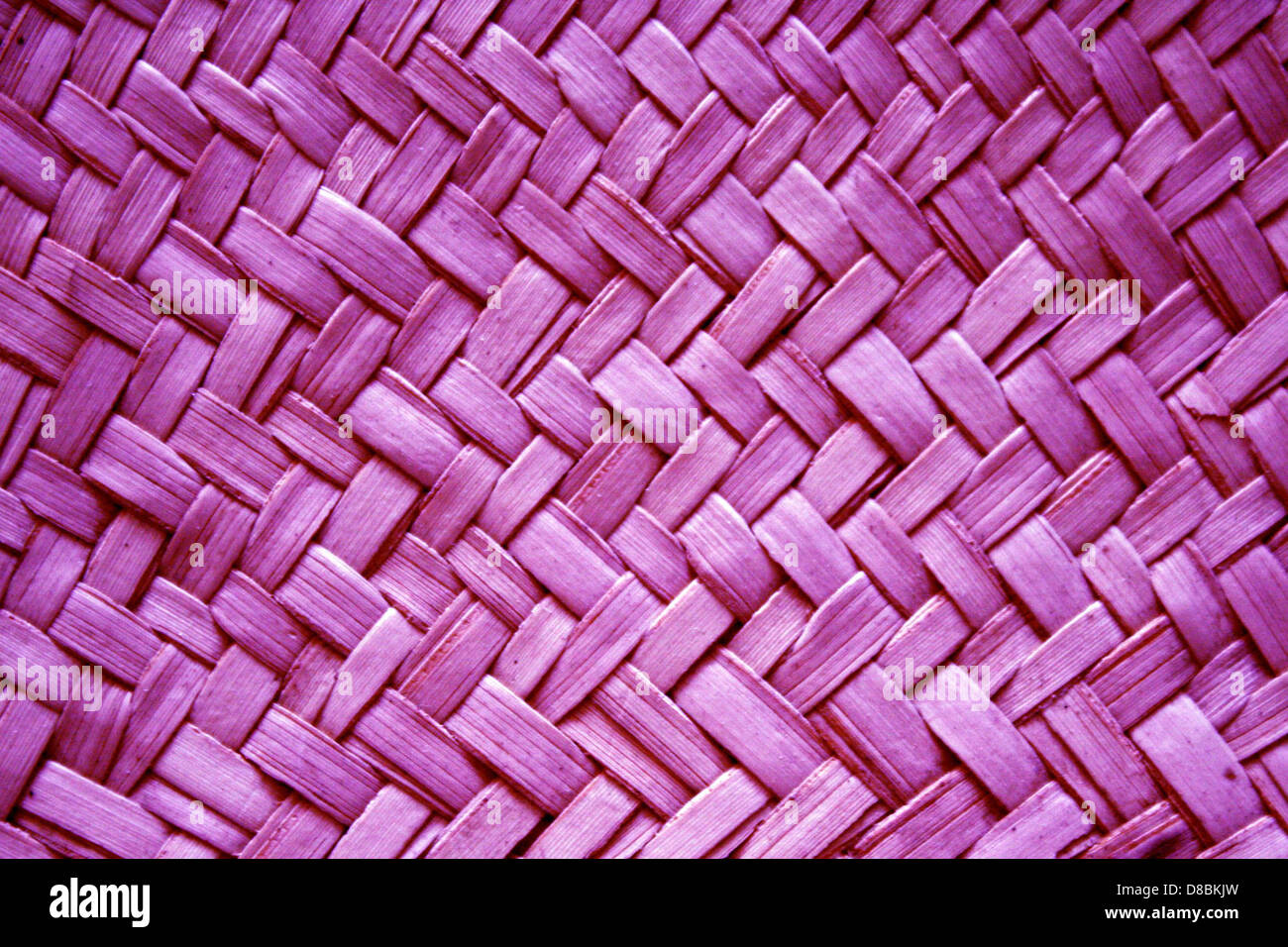 A close-up image of a woven straw texture in shades of purple. The ...