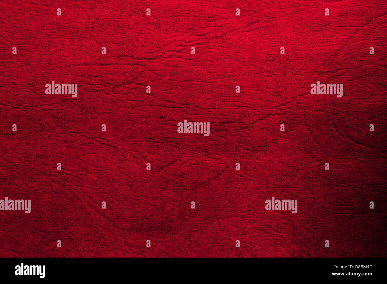 A close-up of red leather, showcasing its smooth texture and rich color ...