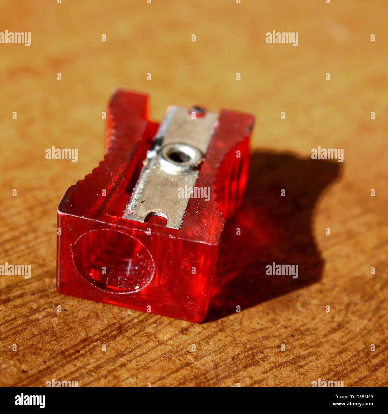 red plastic pencil sharpener Stock Photo - Alamy