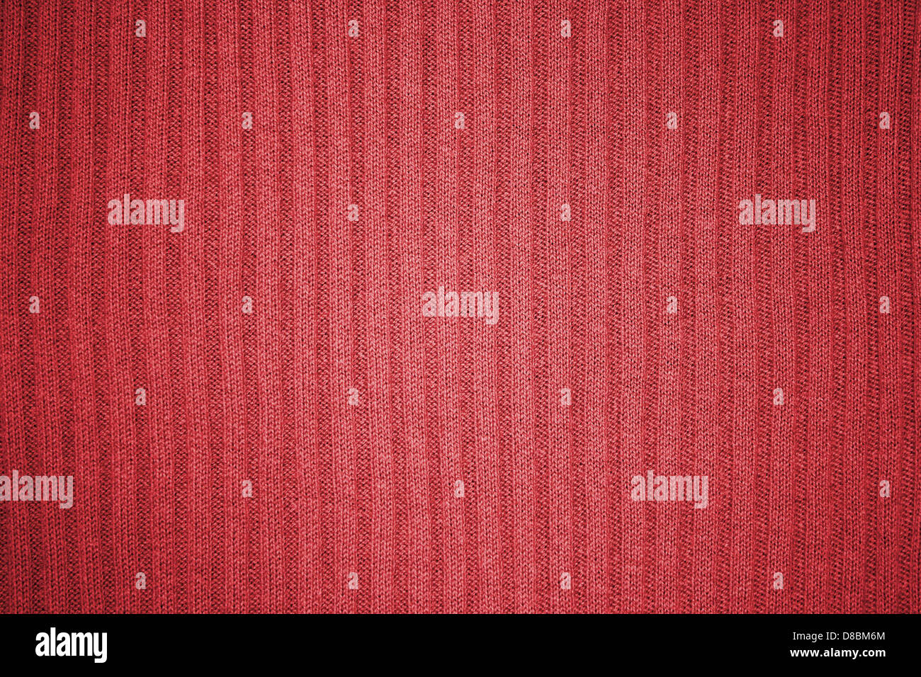 A close-up of red ribbed knit fabric shows the texture created by ...