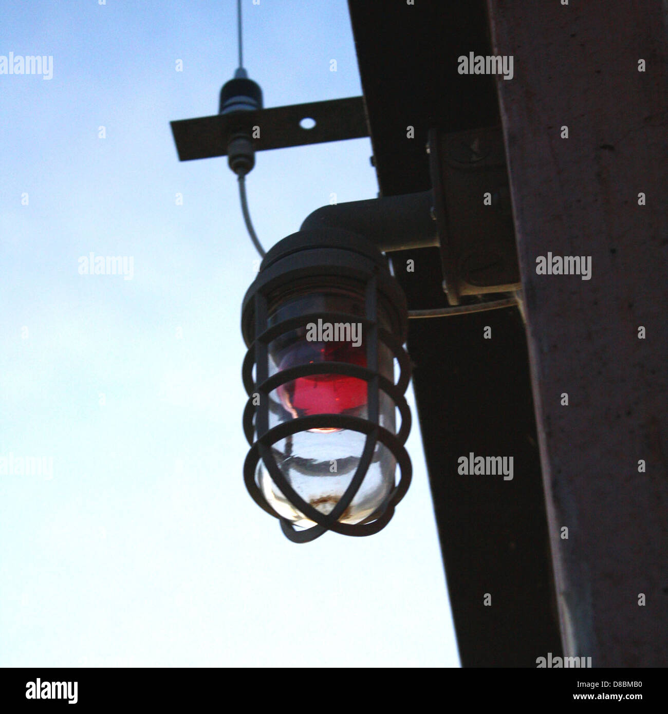 A red security light, often used for night surveillance, casts a ...