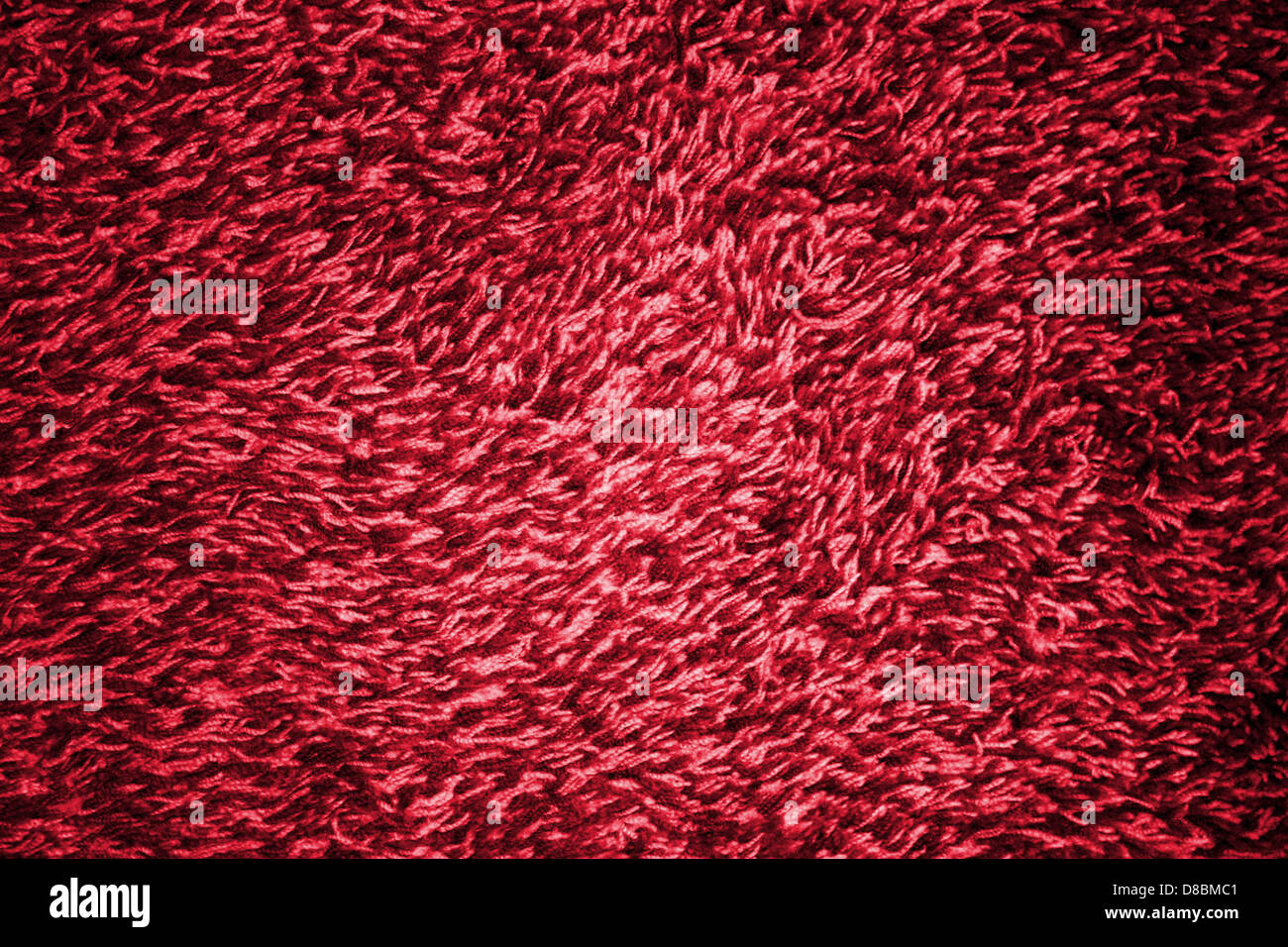 A close-up photo of red shag carpeting, emphasizing the thick, plush ...