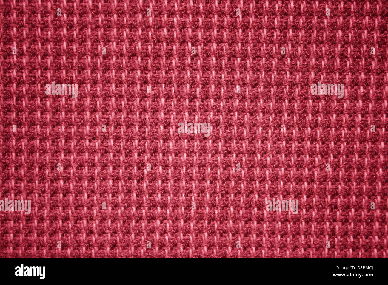 Close-up of a red upholstery fabric with intricate texture details. The ...