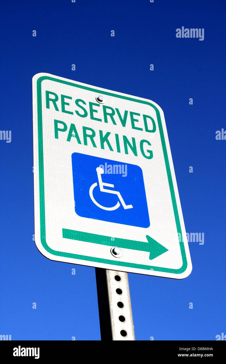 A reserved wheelchair parking sign featuring an arrow, clearly marking ...