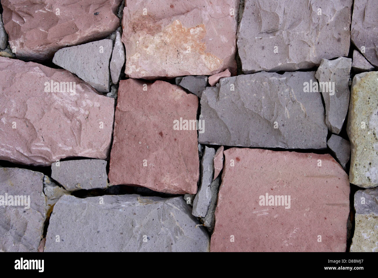 A detailed close-up of a rock wall surface, highlighting its rugged ...