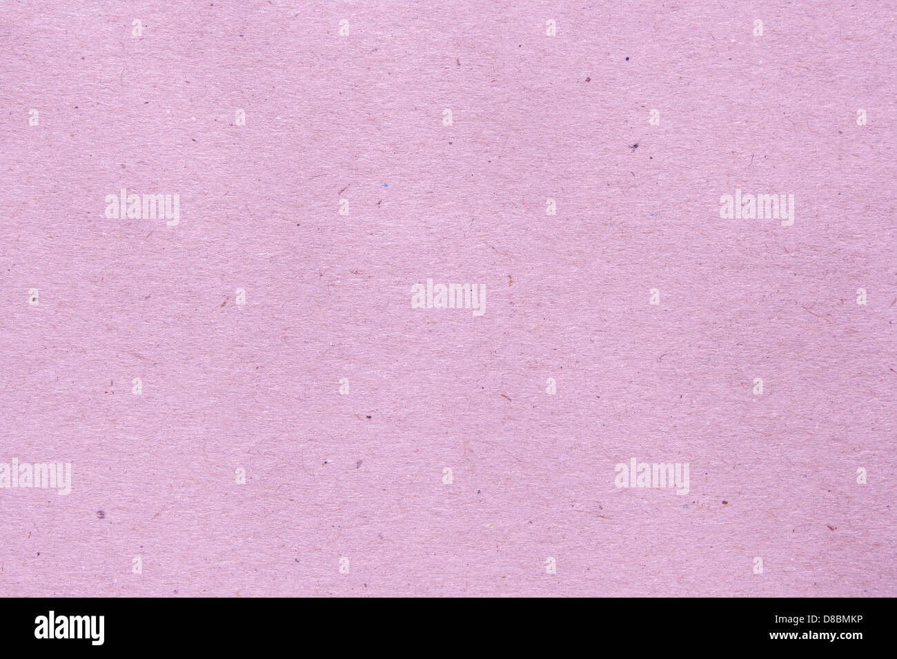 A close-up of rose-colored paper with flecks throughout the surface ...