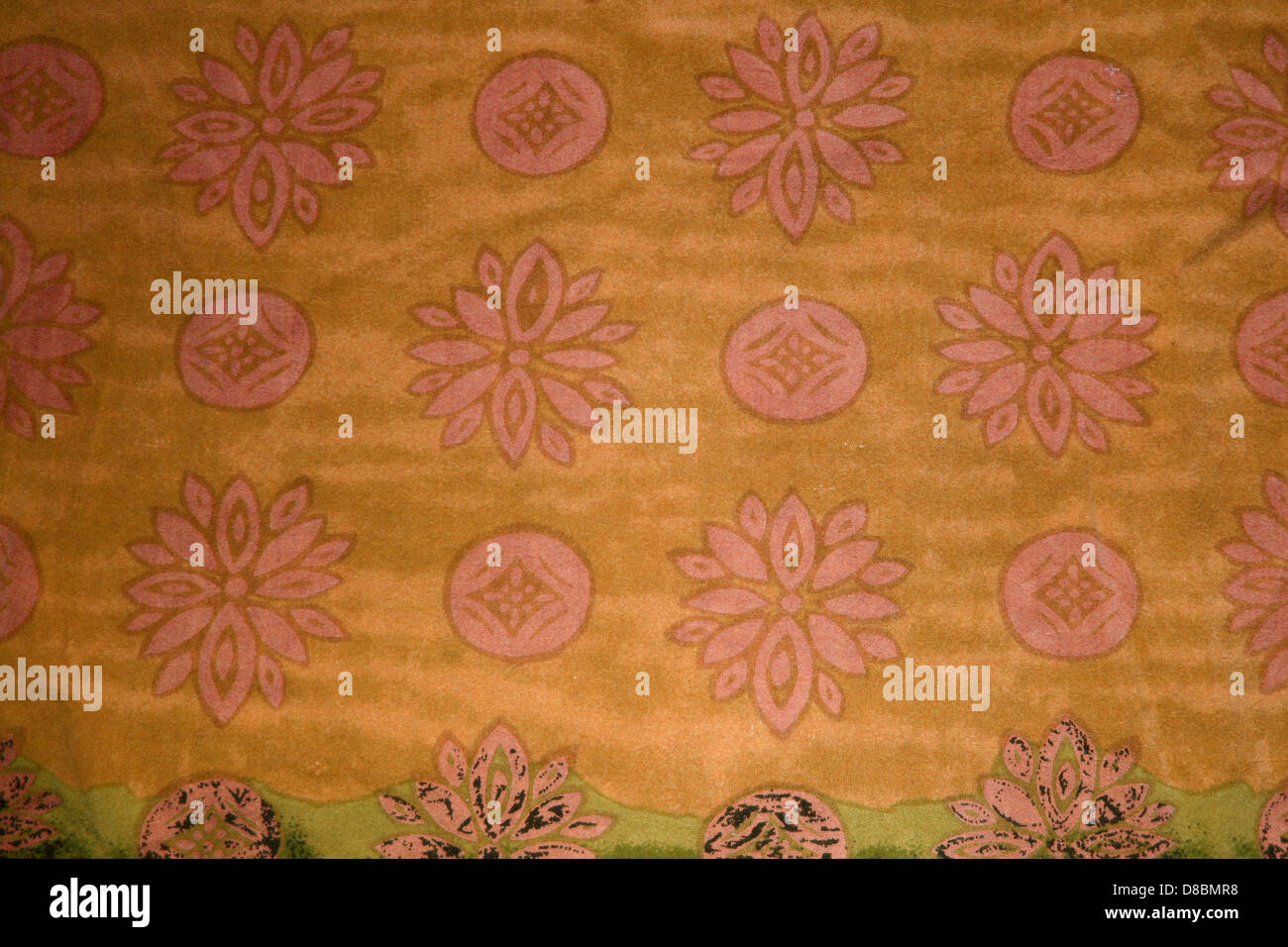 A fabric with a rust orange color featuring a design of flowers and ...