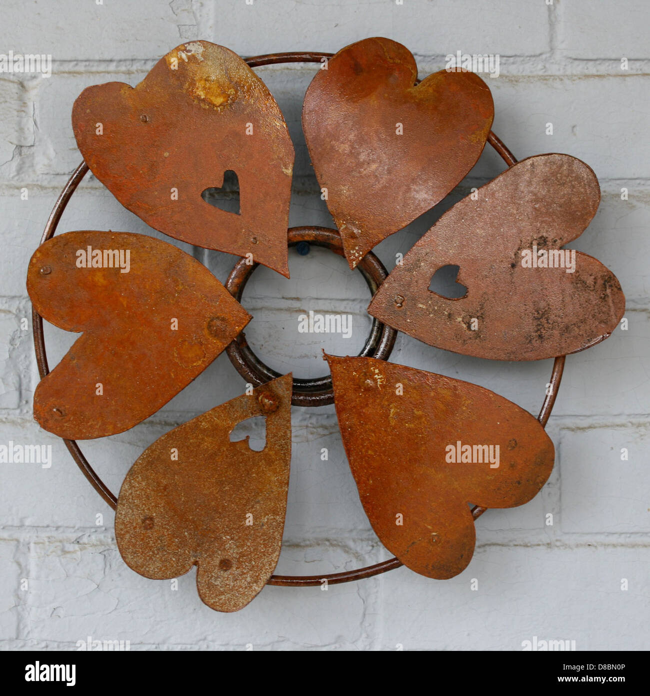 A rusted metal heart wreath decoration, often used as rustic home decor ...