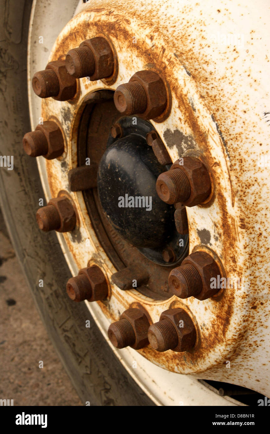 A close-up of a rusty truck wheel, showing signs of wear and corrosion ...