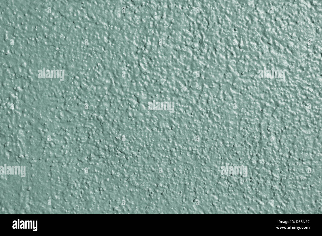 A close-up of a wall painted in sage green, showcasing the smooth ...