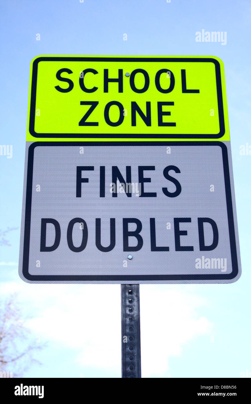 A school zone street sign indicating a reduced speed limit in areas ...