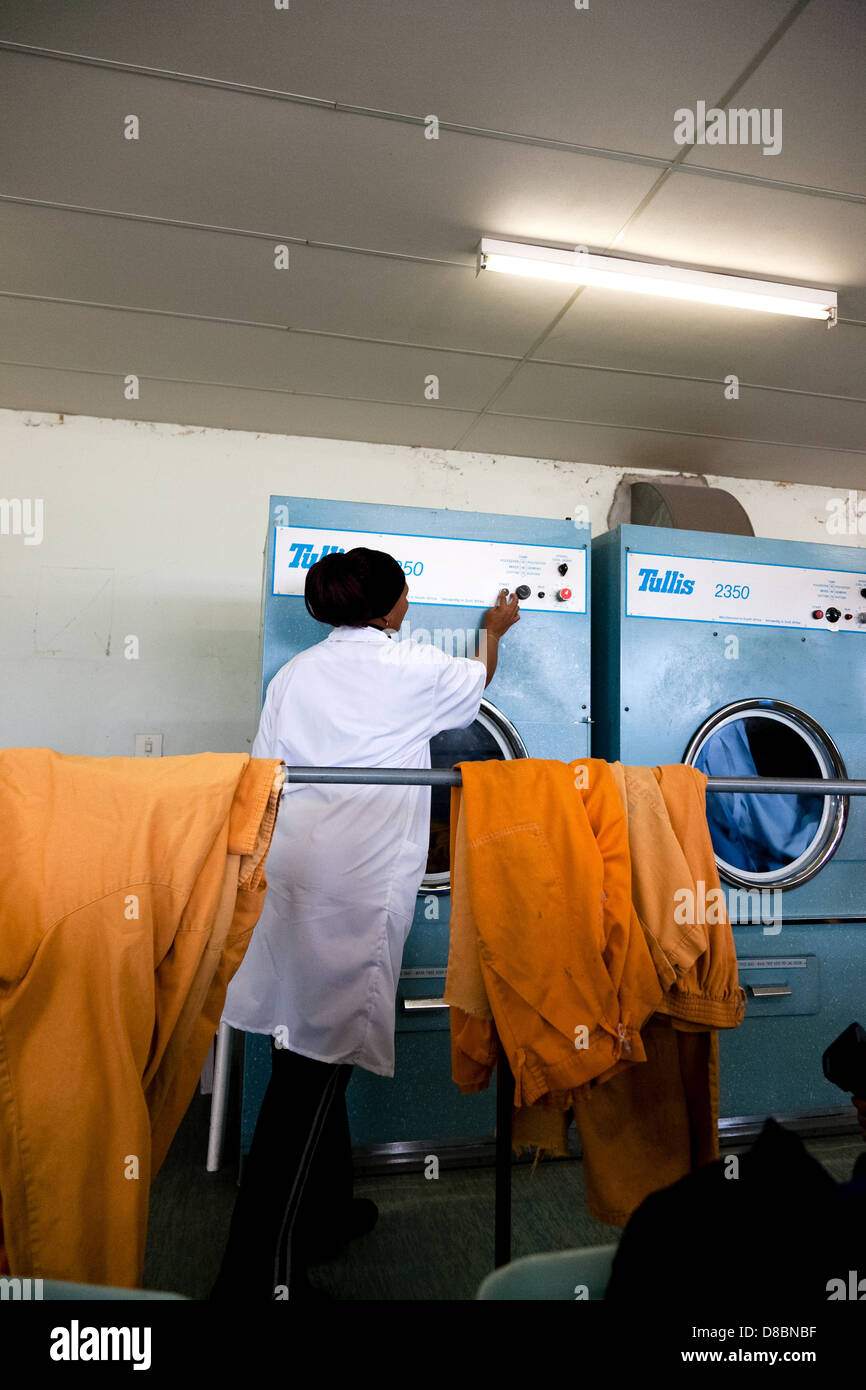 lady in white operating washing machine Stock Photo - Alamy