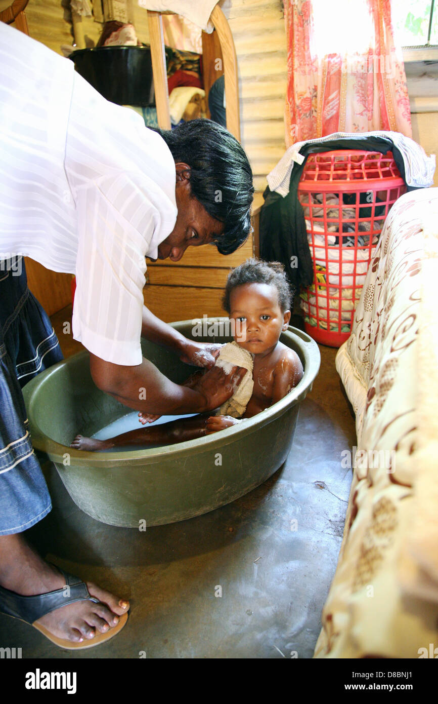 Mother Bathing Baby In Africa