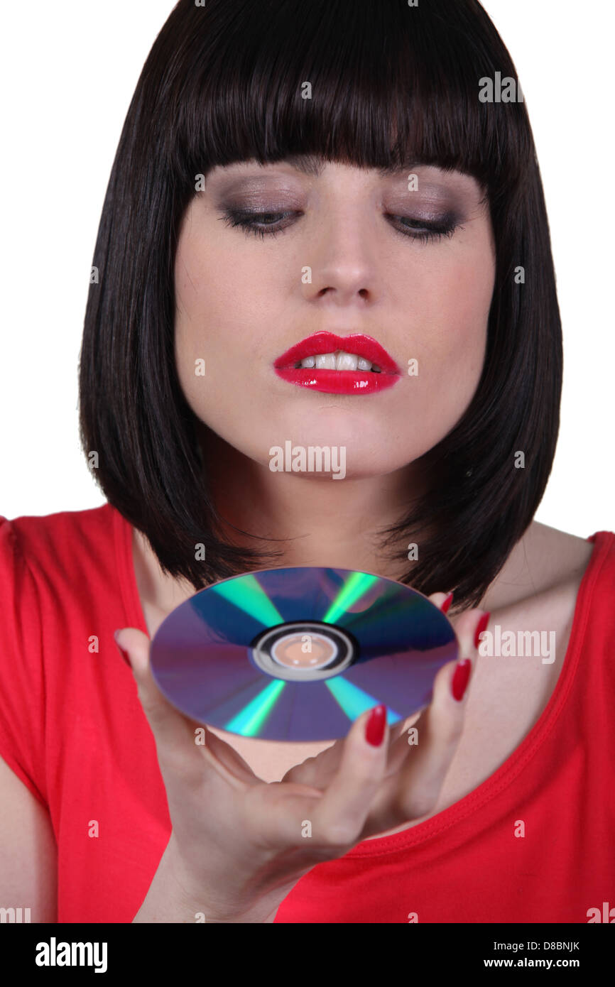 brunette woman looking a cd Stock Photo - Alamy
