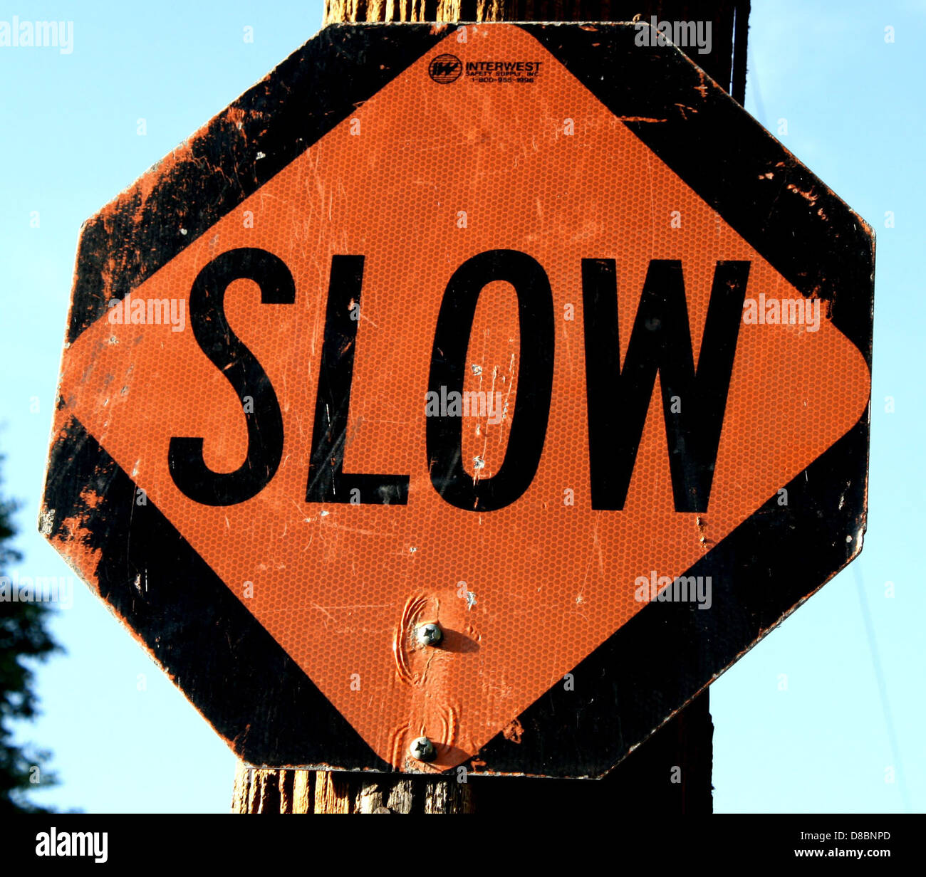 A road sign displaying the word 'Slow,' indicating reduced speed for ...