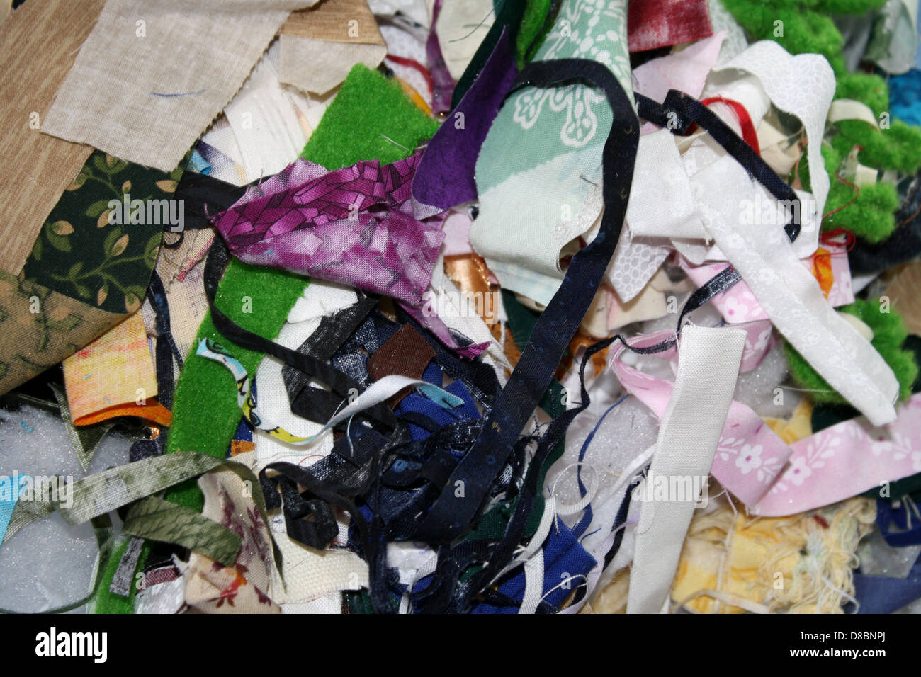 A collection of small pieces of scrap fabric in various colors and ...