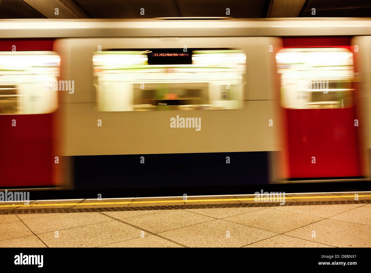 Red train on London's underground railway Stock Photo - Alamy