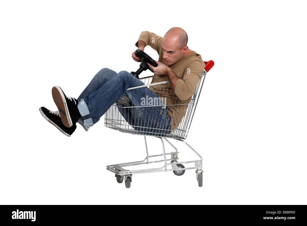 Man sat in trolley with toy steering wheel Stock Photo - Alamy