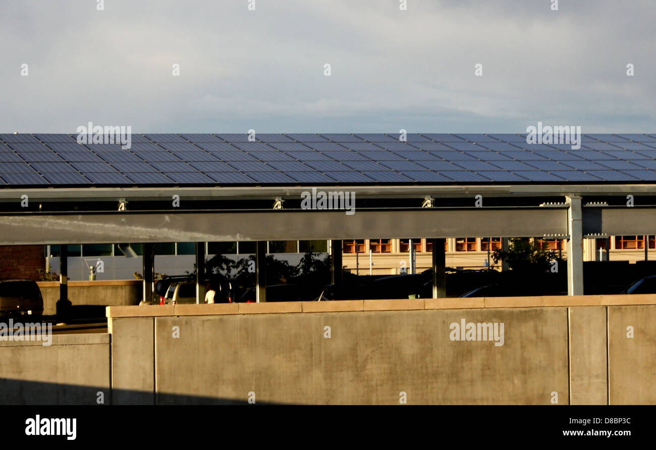 This image shows solar panels installed on the roof of a parking garage ...