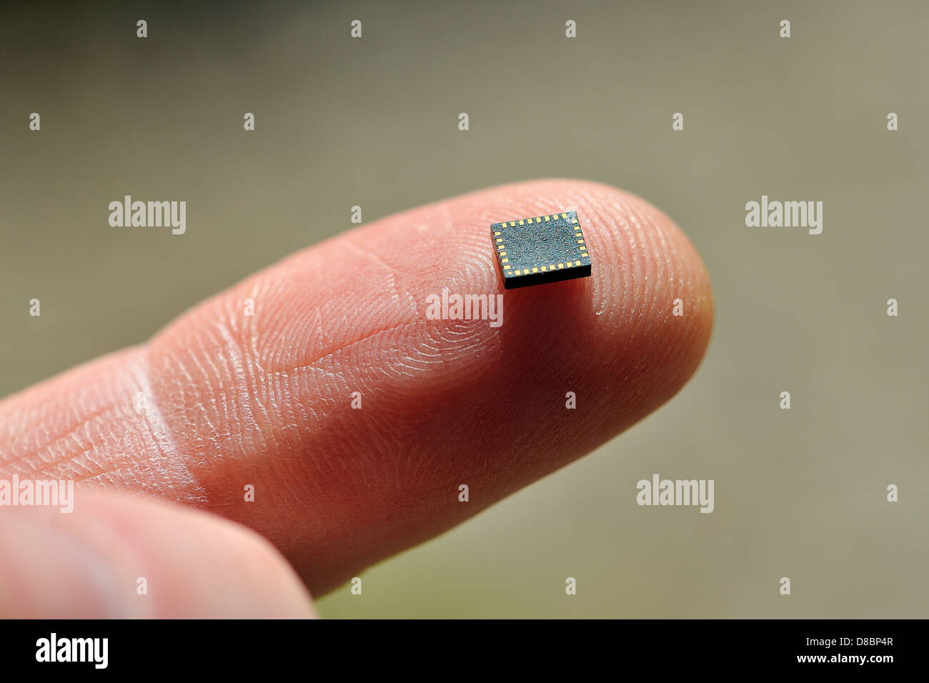 Miniature MEMs device on human finger Stock Photo - Alamy