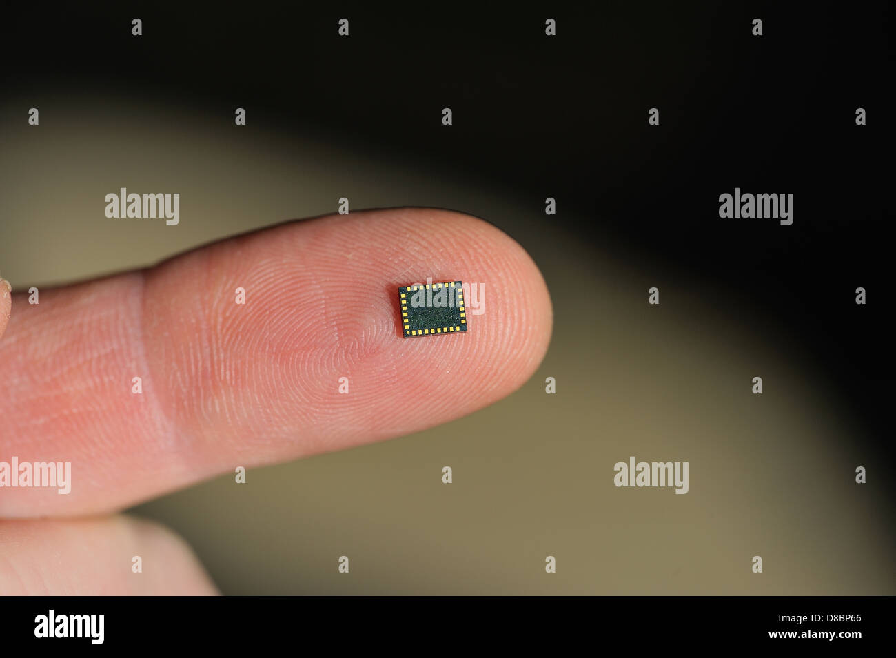 Miniature MEMs device on human finger Stock Photo - Alamy