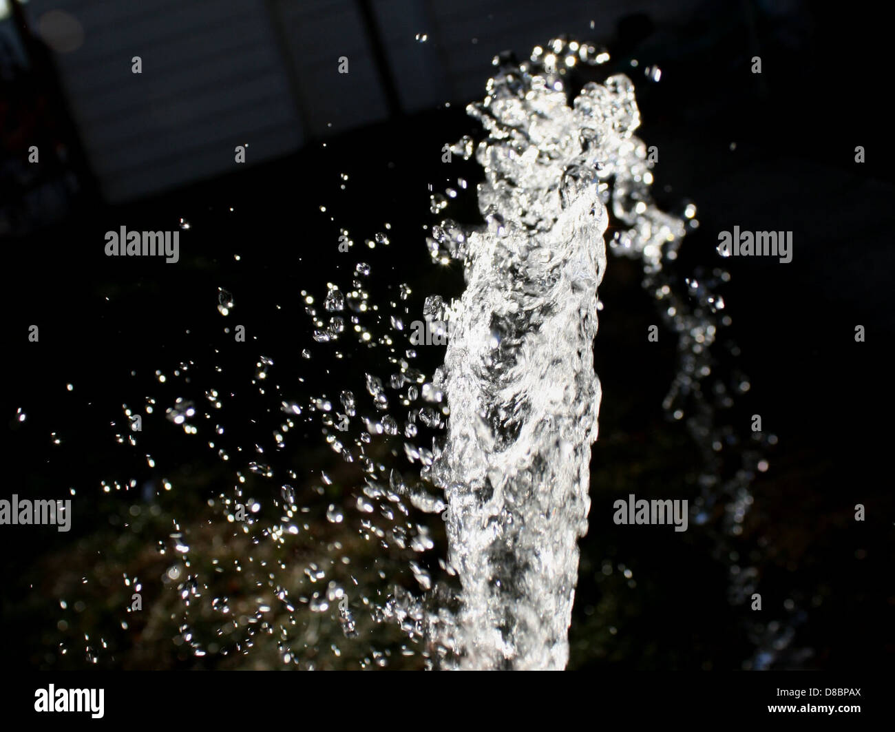 A dynamic image of water being sprayed, captured in motion. The water ...